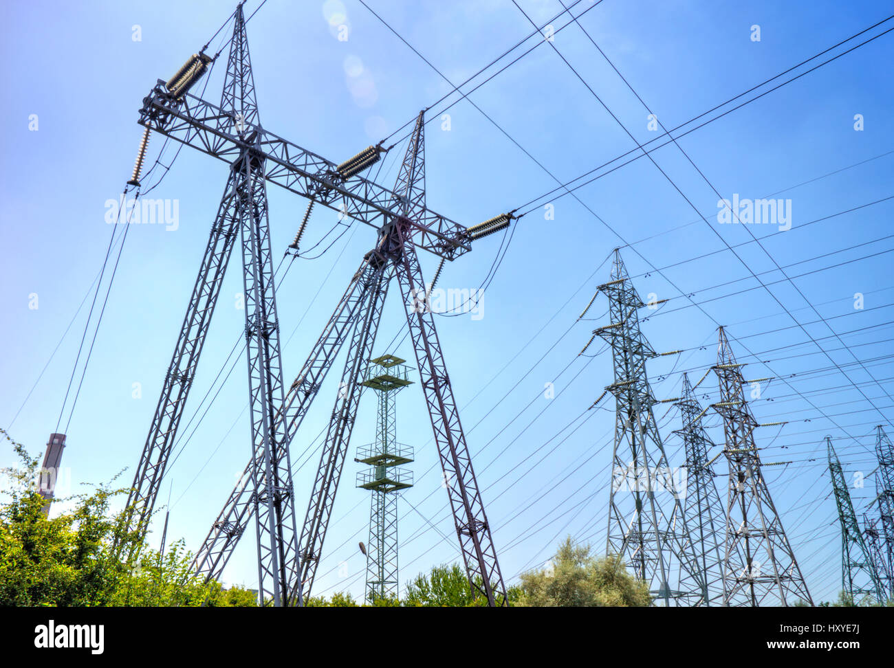 High voltage electrical overhead lines on blue sky Stock Photo - Alamy