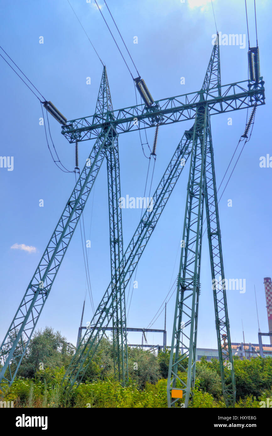High voltage electrical overhead lines on blue sky Stock Photo - Alamy