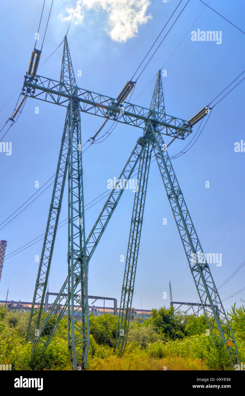 High voltage electrical overhead lines on blue sky Stock Photo - Alamy