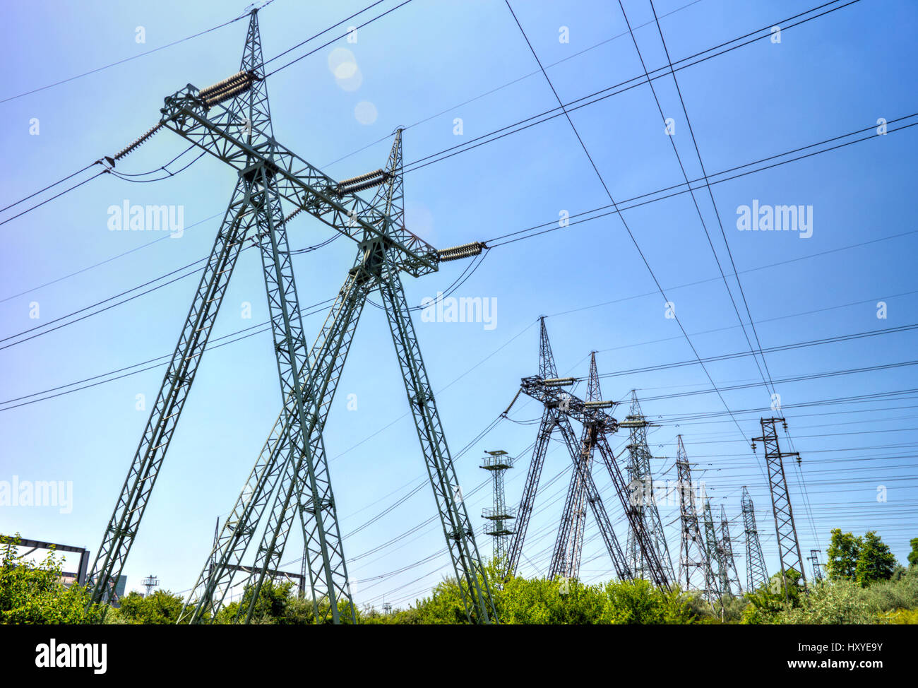 High voltage electrical overhead lines on blue sky Stock Photo - Alamy