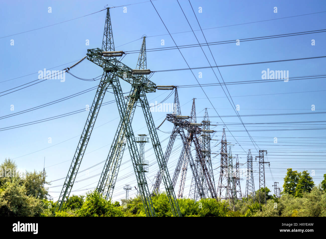 High voltage electrical overhead lines on blue sky Stock Photo - Alamy
