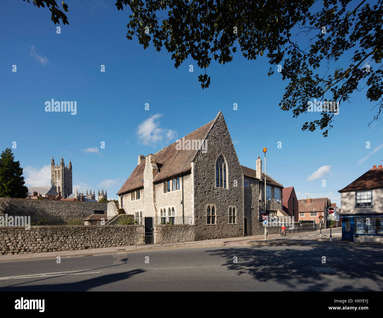 Street view along perimeter wall with old and new buildings and ...