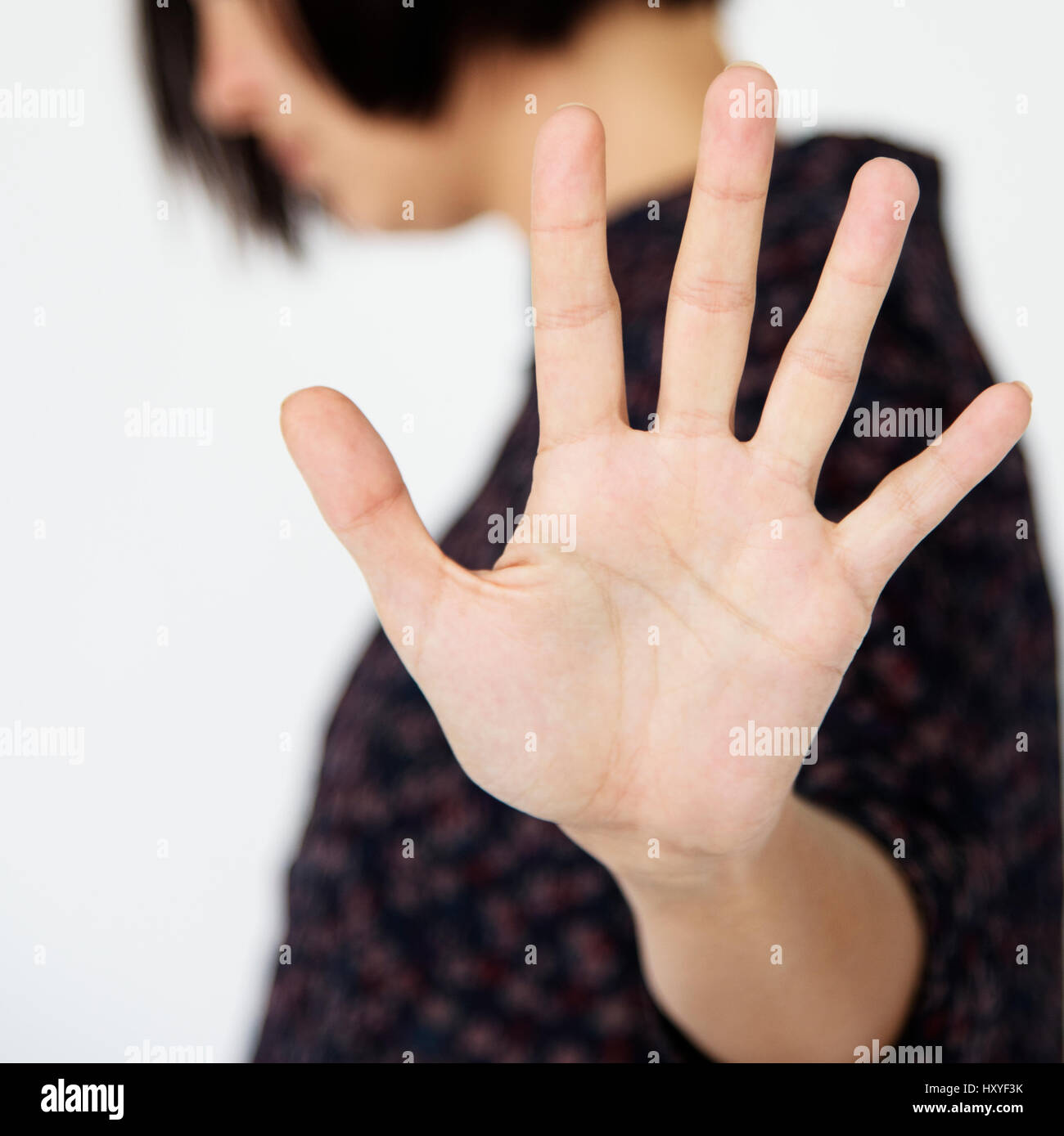 Woman doing stop hand gesture studio Stock Photo - Alamy
