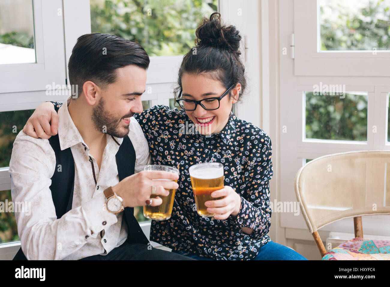 Young modern couple toasting with beer Stock Photo - Alamy