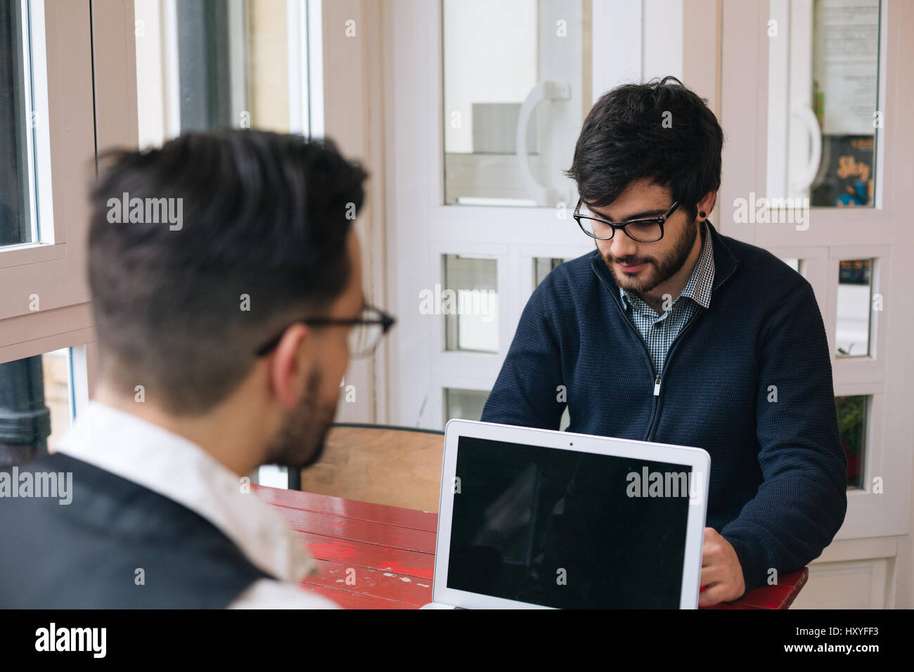 Young modern men using technology devices in a cafe bar Stock Photo - Alamy