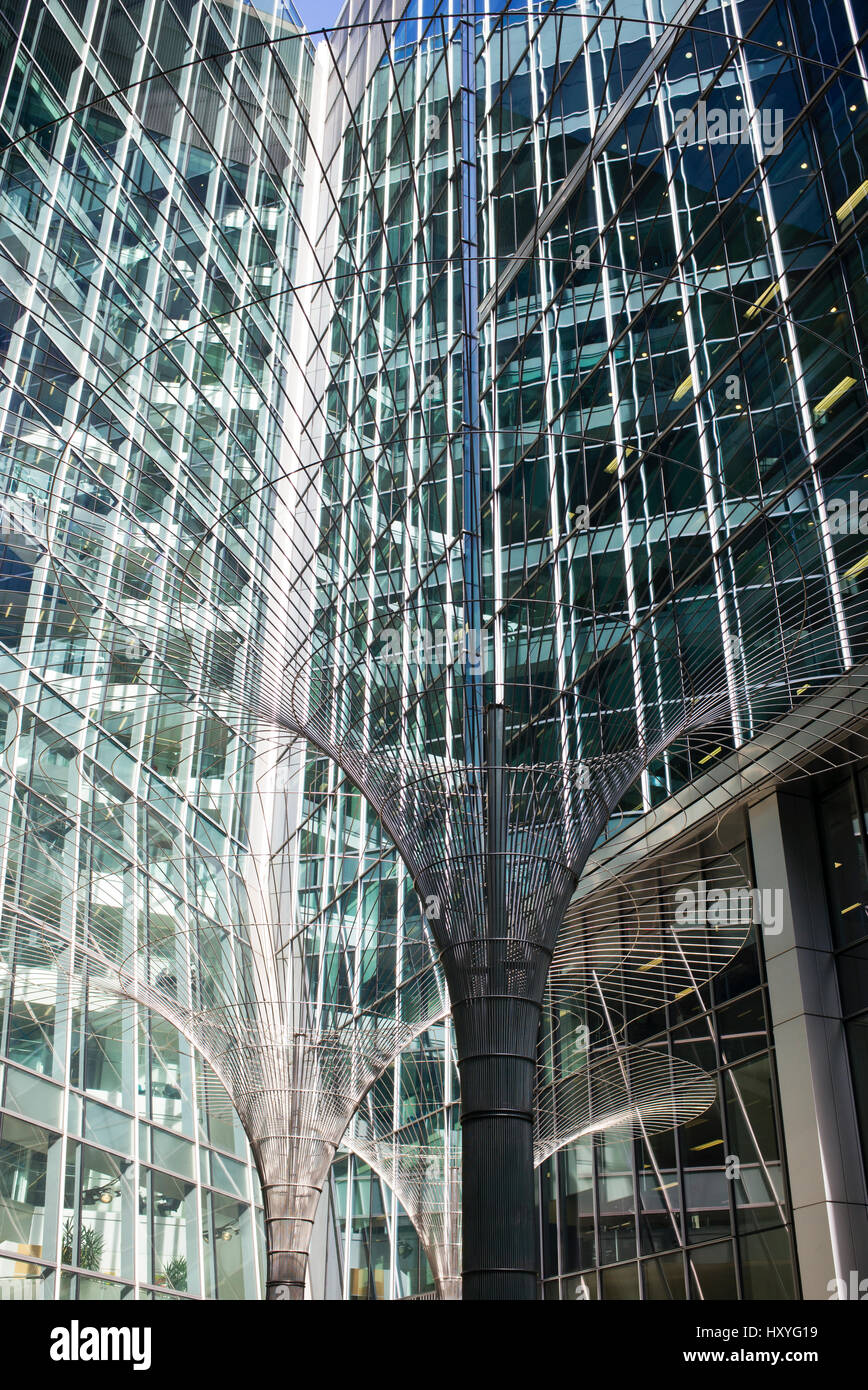 Wire tree sculptures and office buildings. Canary Wharf. London Stock ...