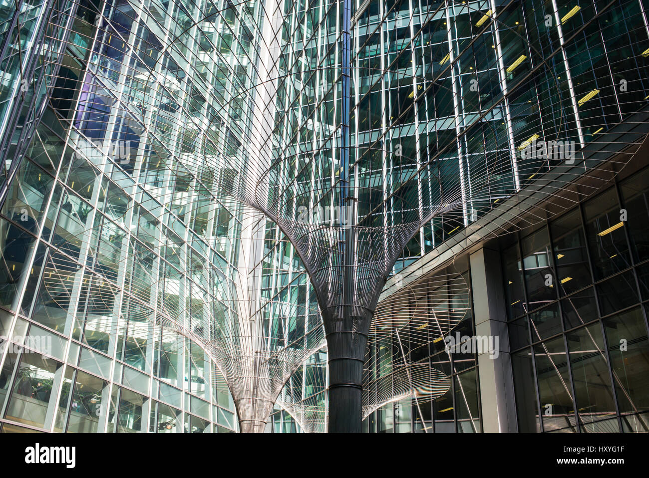 Wire tree sculptures and office buildings. Canary Wharf. London Stock ...