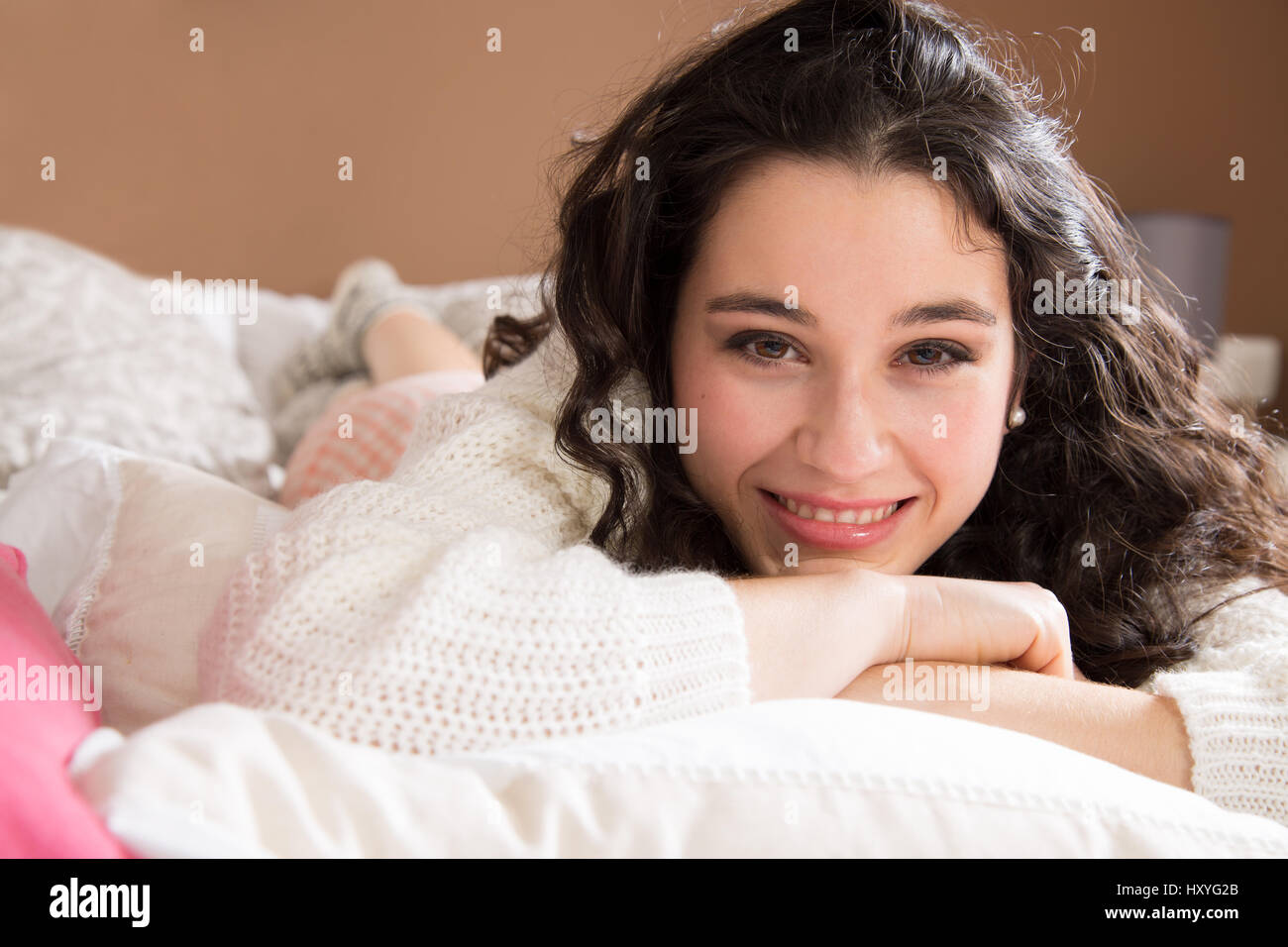 Happy beautiful woman resting in bed Stock Photo - Alamy