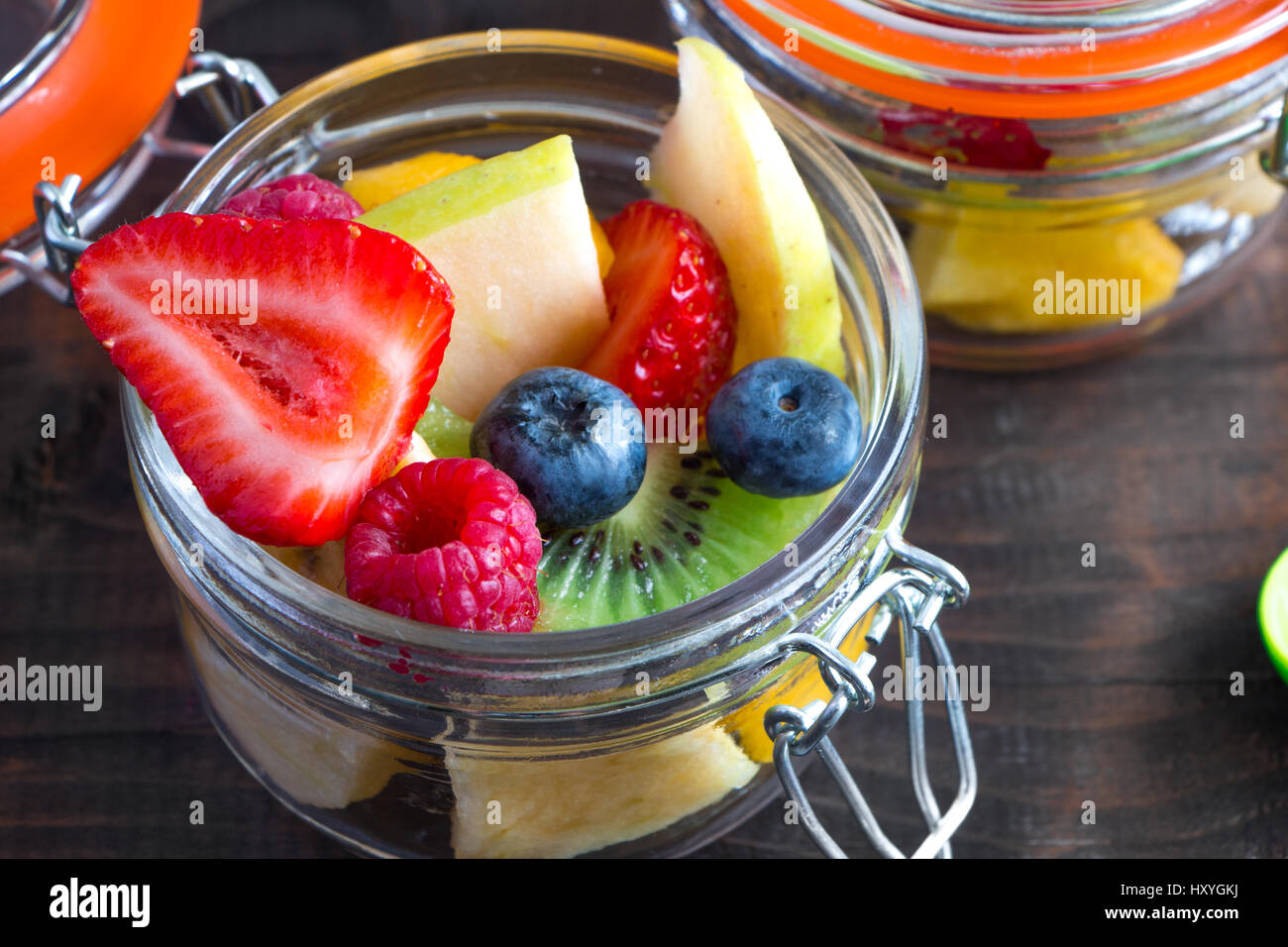 Beautiful and colorful fresh fruit salad in little jars to take away ...