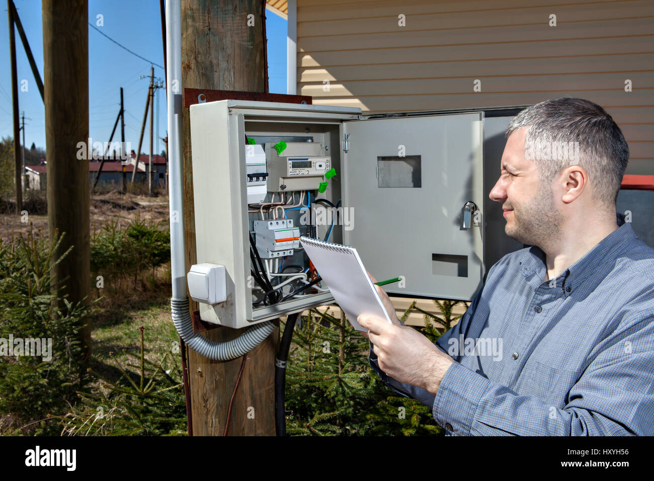 Country electrician engineer inspecting electric counter equipment in ...