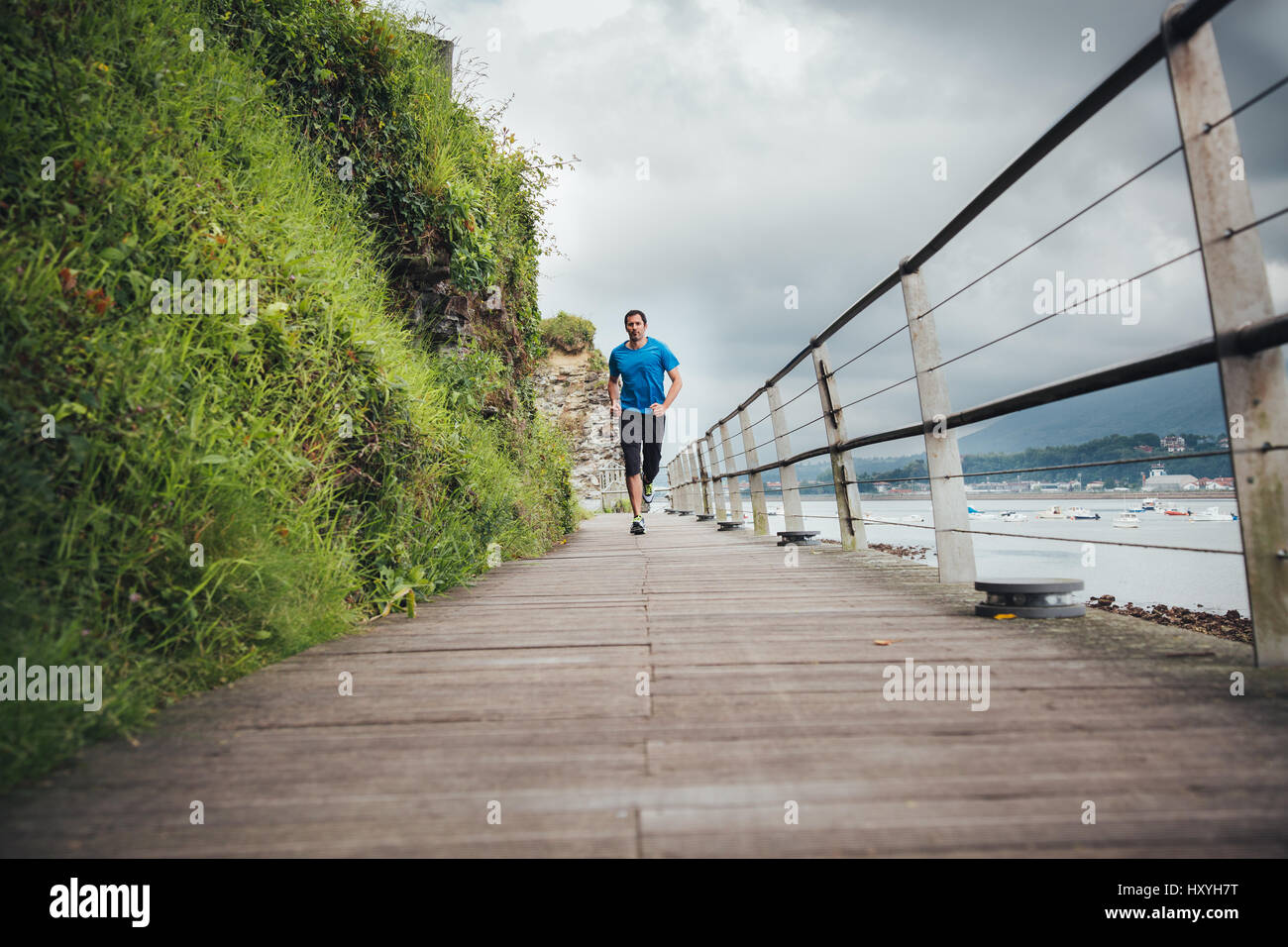 Athletic man running in rainy hi-res stock photography and images - Alamy