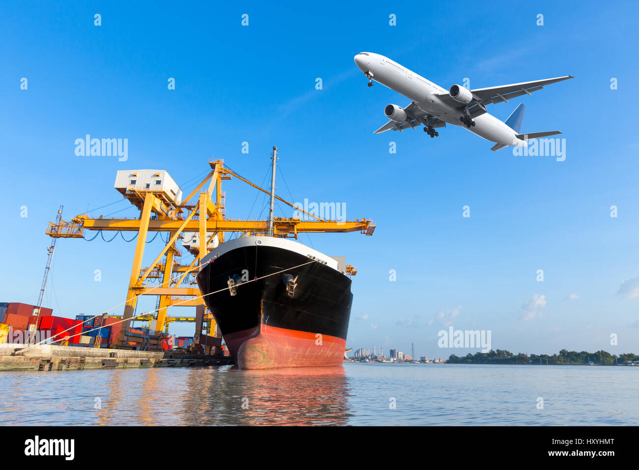 Container cargo freight ship with working crane loading bridge in ...