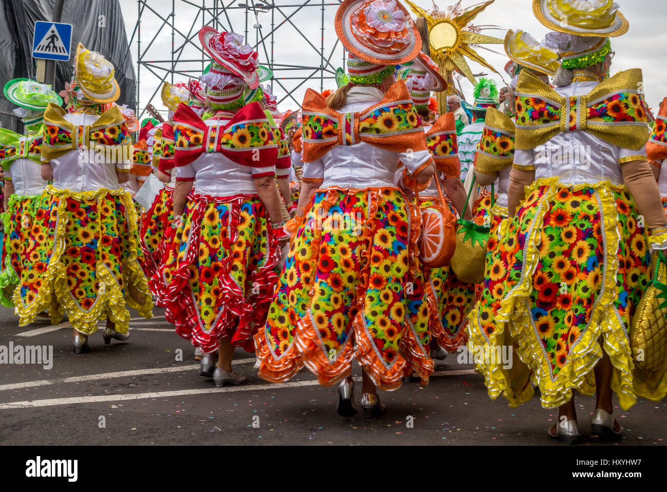 Back view of group of women in very elaborate colorful costumes in the ...