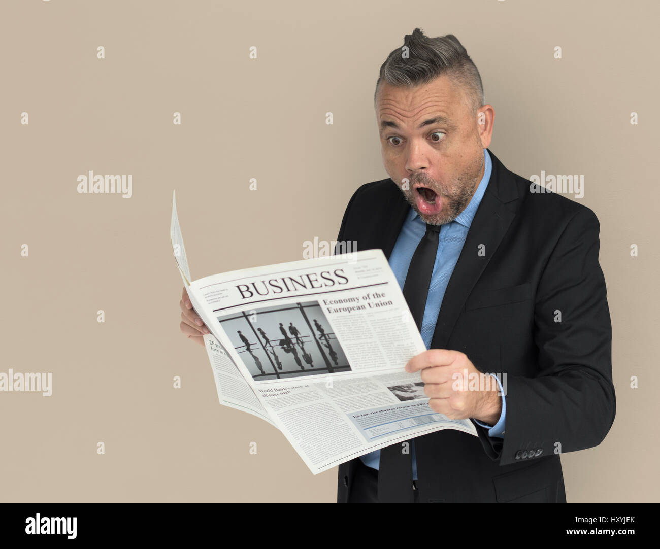Caucasian Business Man Reading Newspaper Shocked Stock Photo - Alamy
