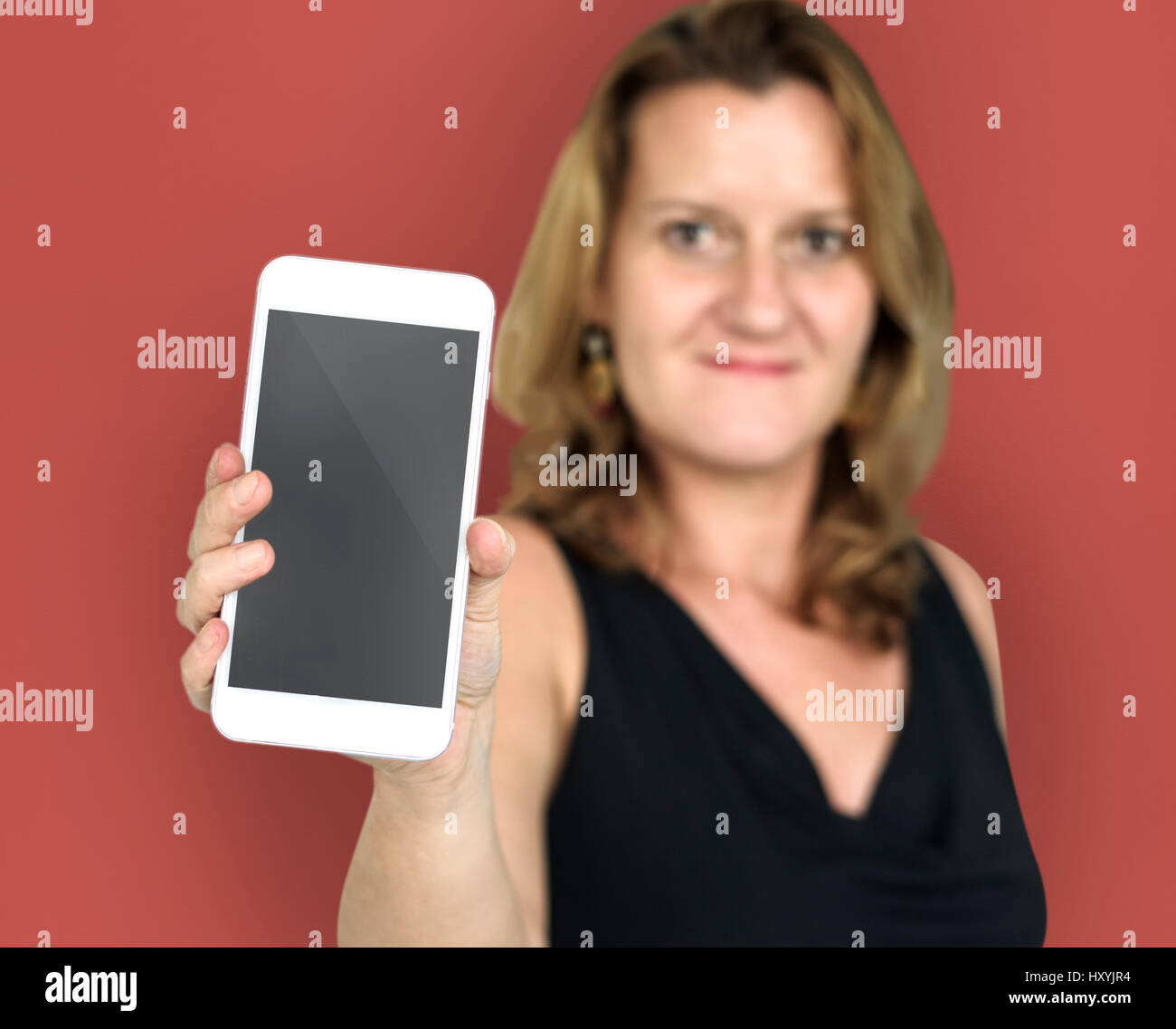 Caucasian Lady Holding Phone Smiling Stock Photo - Alamy