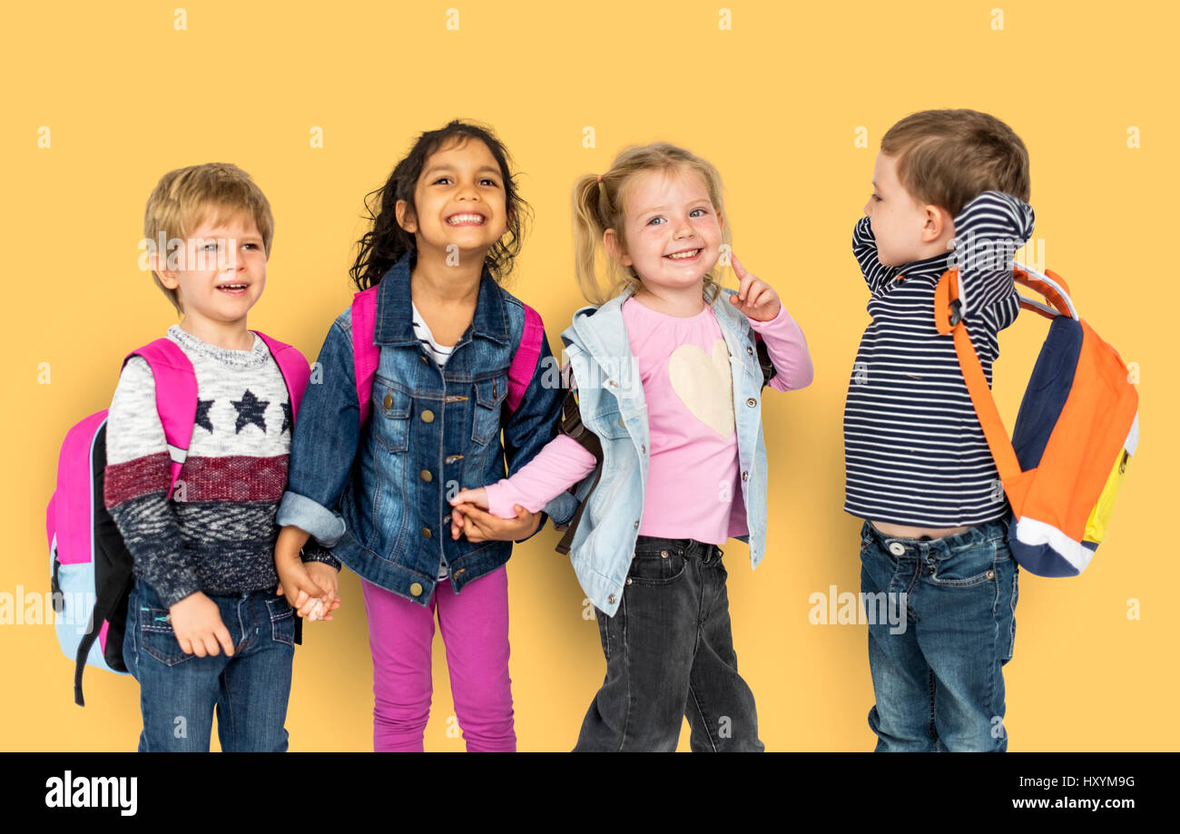 Little Kids Holding Hands Carrying Backpacks Stock Photo - Alamy