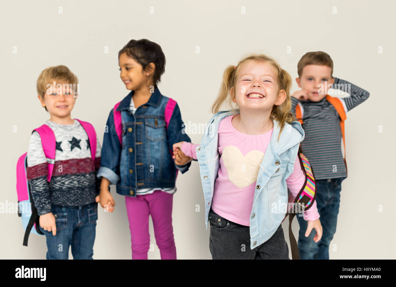 Little Kids Holding Hands Carrying Backpacks Stock Photo - Alamy