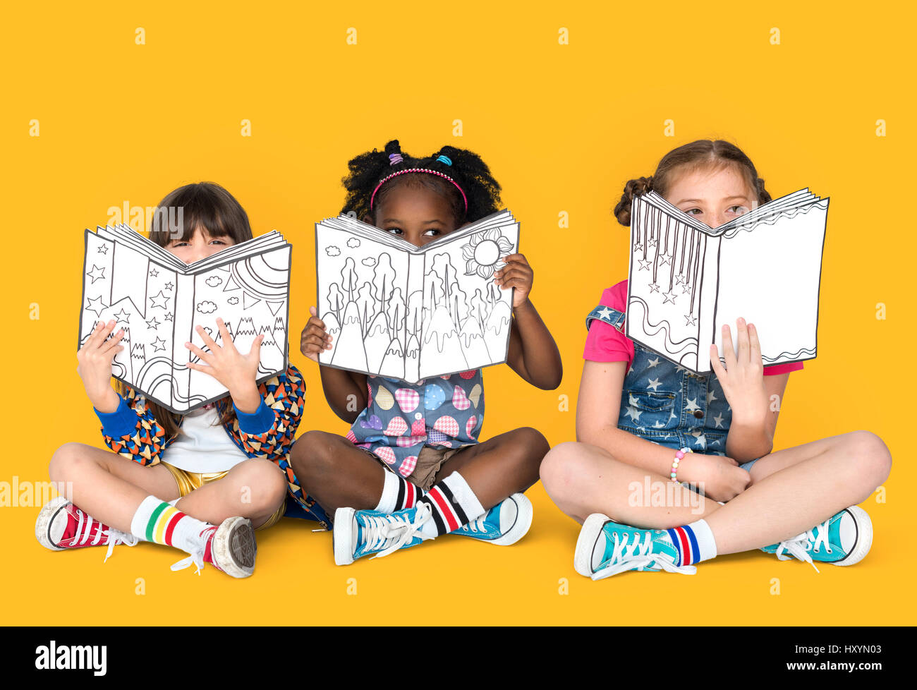 Little Children Reading Sitting Down Stock Photo - Alamy