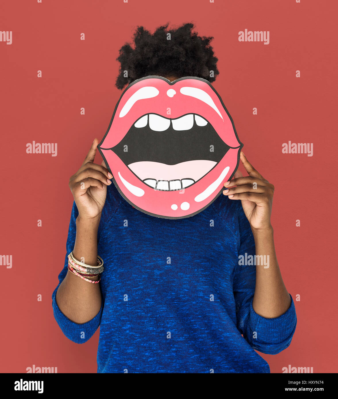 African Woman holding Peper Mouth Over her Face Stock Photo - Alamy