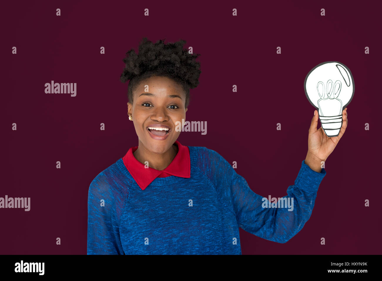 African Descent Woman Holding Light Bulb Stock Photo - Alamy