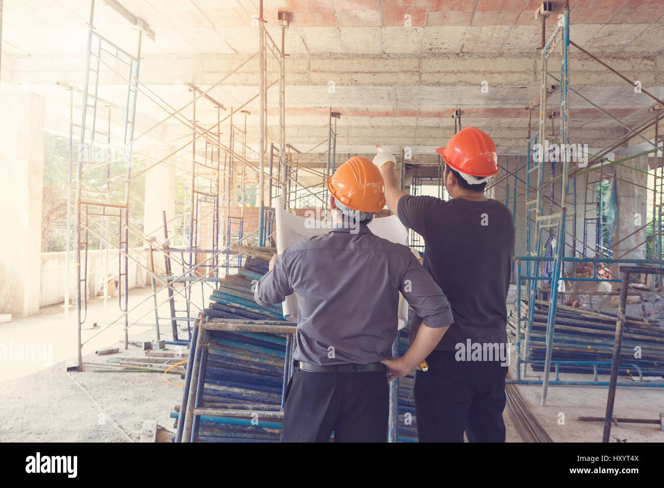 Construction concepts, Engineer and Architect working at Construction Site with blueprint Stock ...
