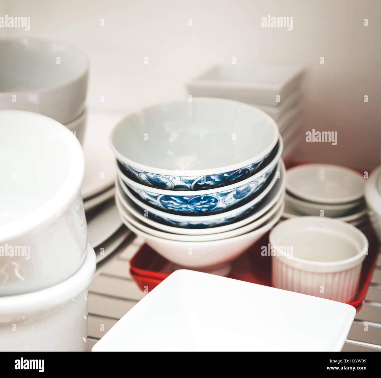 Dishes stacked on shelves in a kitchen area Stock Photo - Alamy