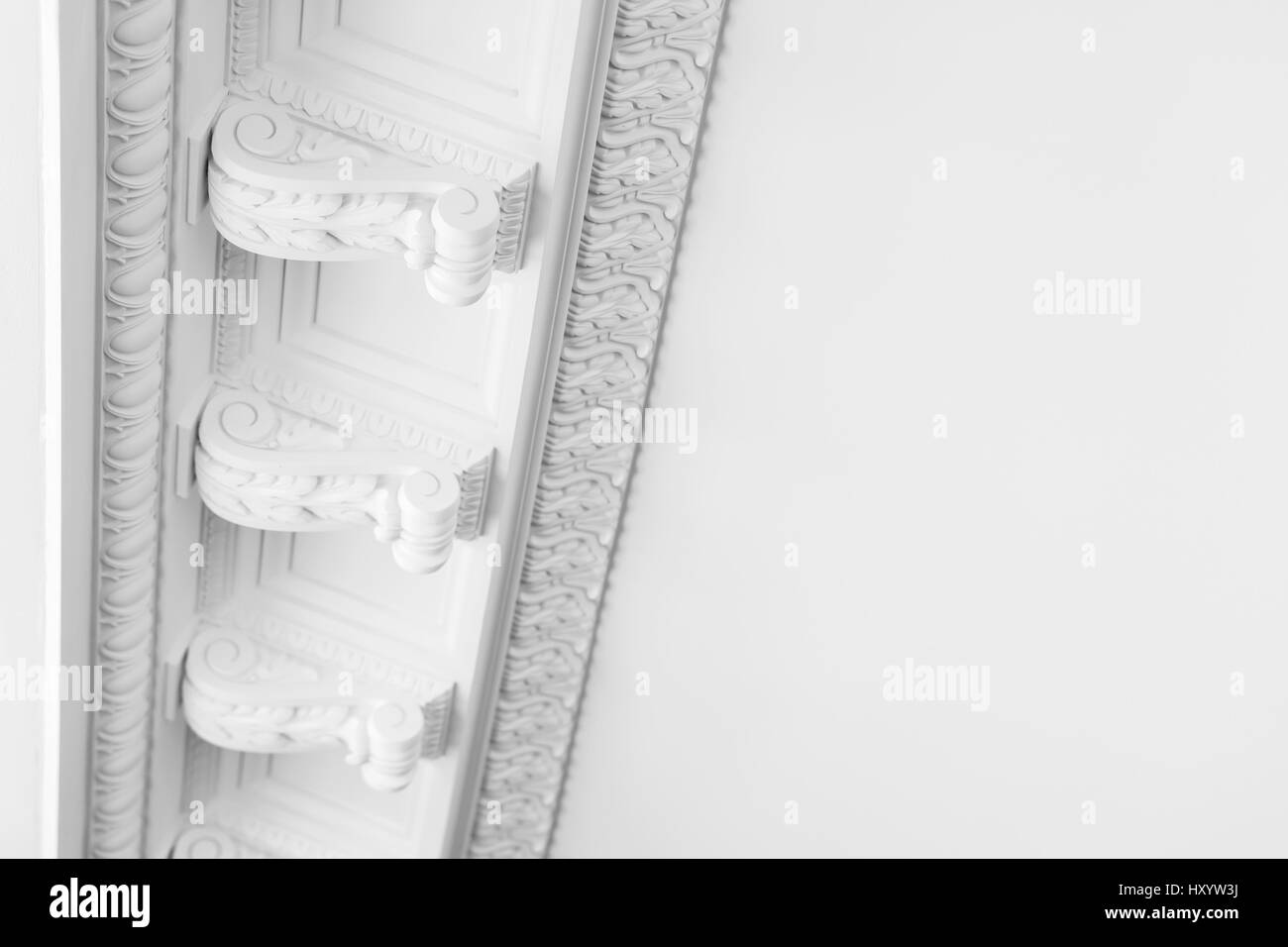 Round decorative clay stucco relief moldings on white ceiling in ...