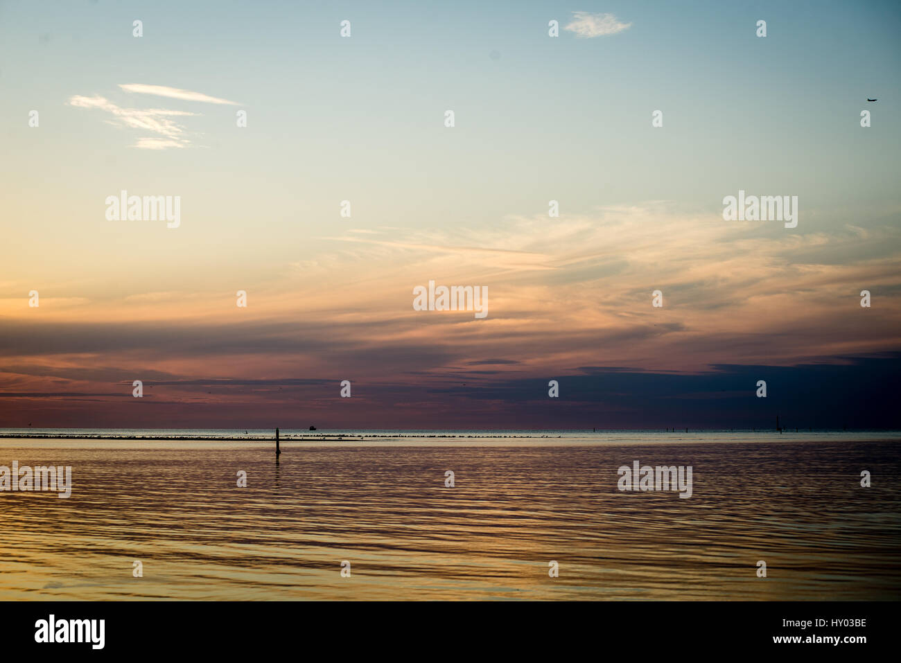 Beautiful summer sunset at the river with blue sky, red and orange ...