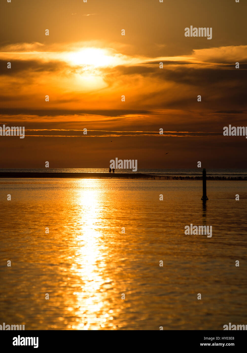 Beautiful sunset over the sea with clouds and reflections Stock Photo ...