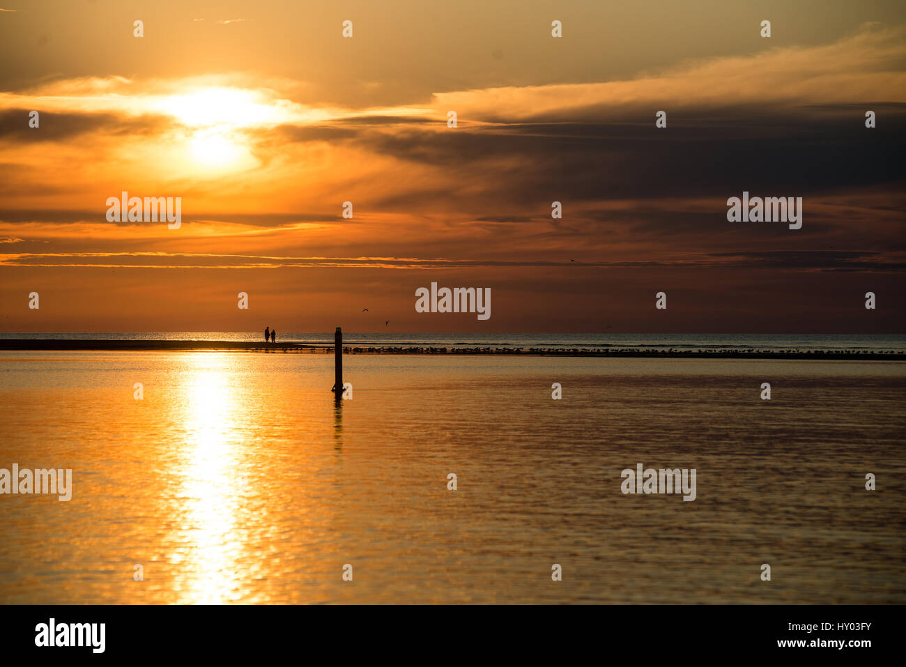 Beautiful sunset over the sea with clouds and reflections Stock Photo ...