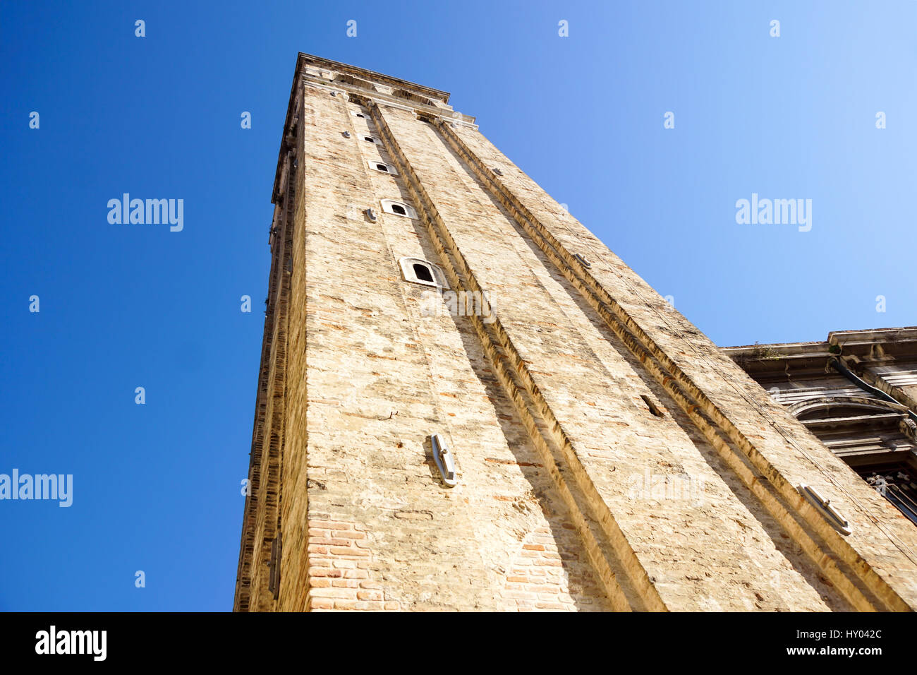 down view on tower of old church building rising up high in the sky ...