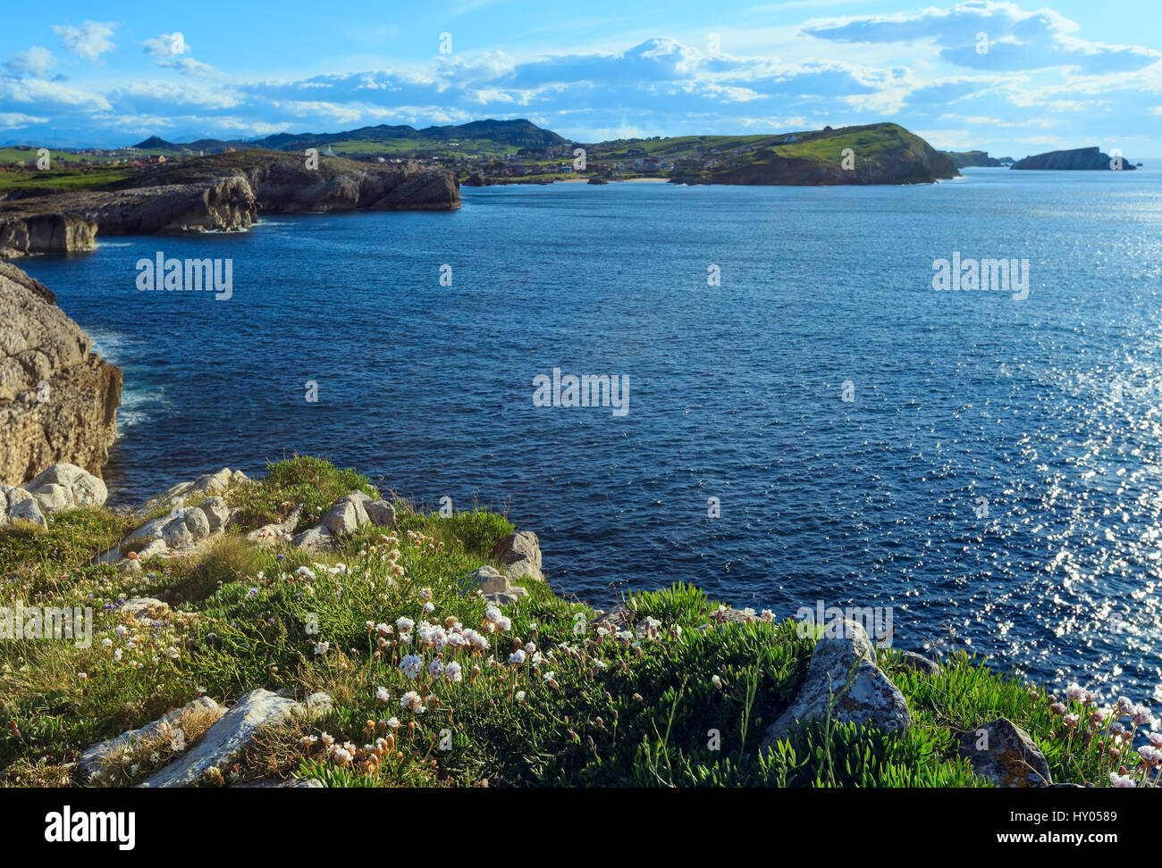 Spring evening Atlantic Ocean coastline landscape with sun reflection ...