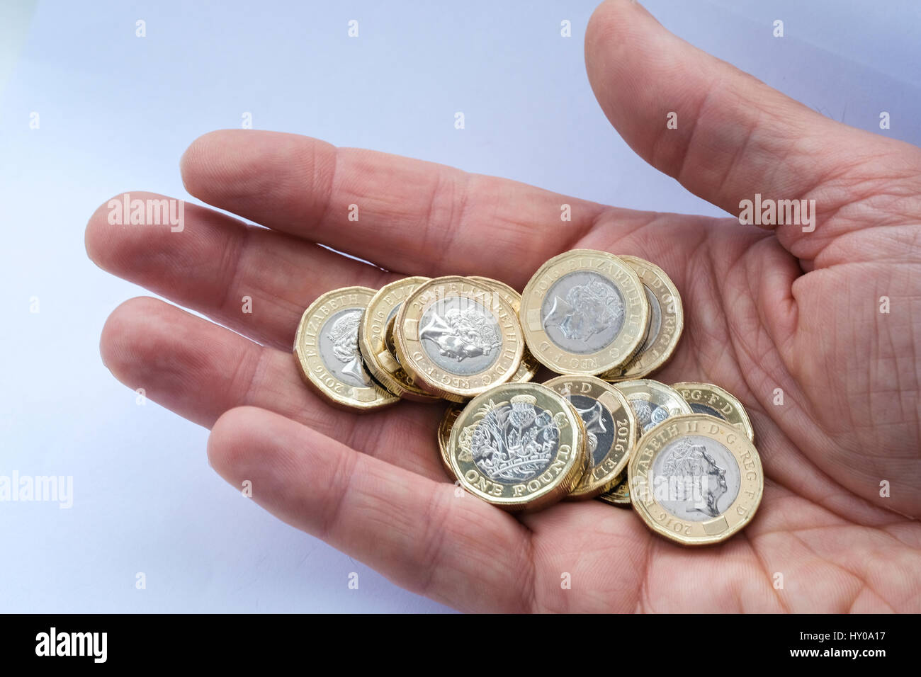 New pound coins in palm of man's hand Stock Photo - Alamy