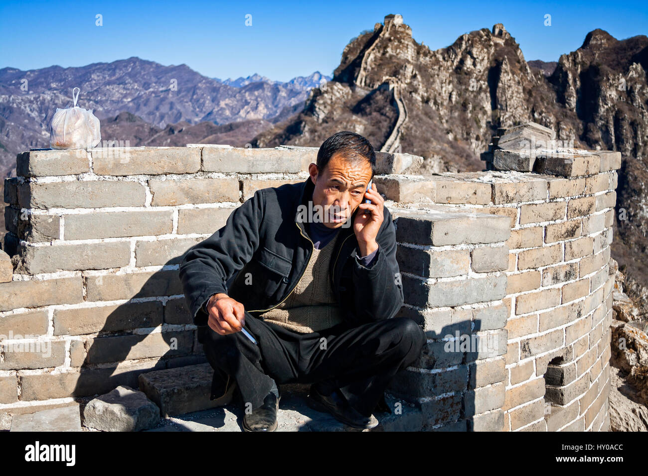 Man squatting smoking cigarette smoking hi-res stock photography and ...