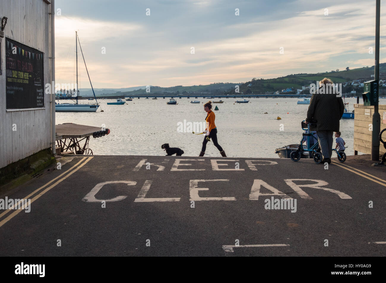 People walking past the ferryboat landing at Teignmouth,Devon, with the ...