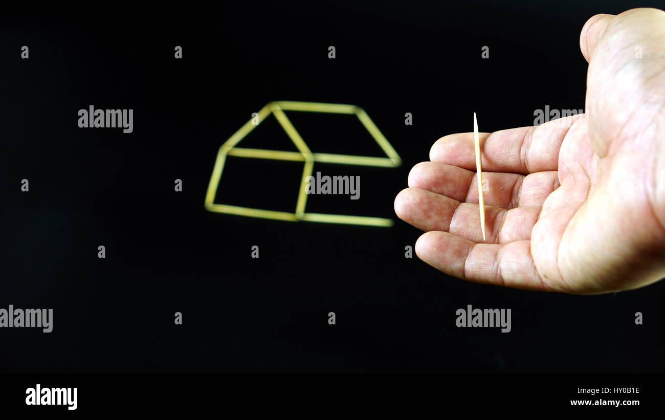Make a house by toothsticks on black background Stock Photo - Alamy
