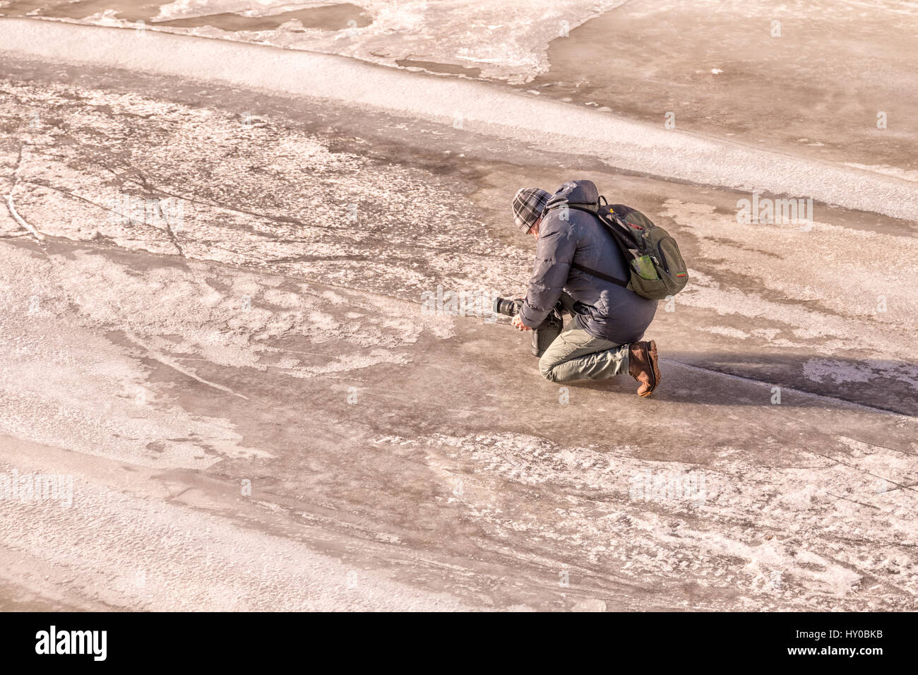 Photographer in the middle of the frozen Griboedov Canal in St ...