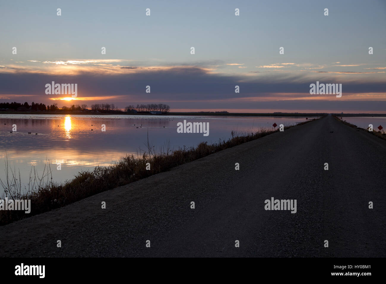 Prairie Sunset lake and road in Canada Stock Photo - Alamy