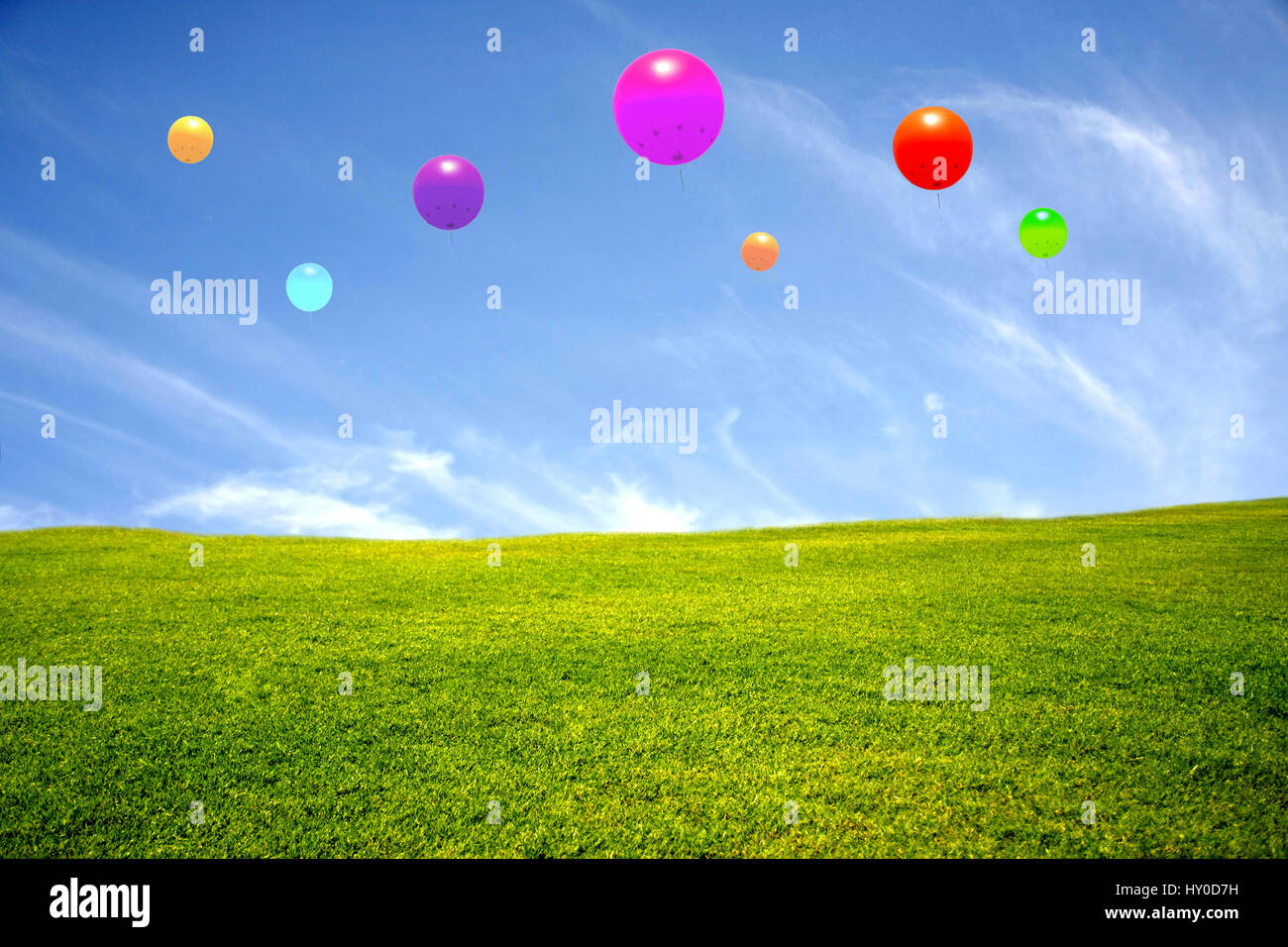 green meadow with blue sky and colorful balloons Stock Photo - Alamy