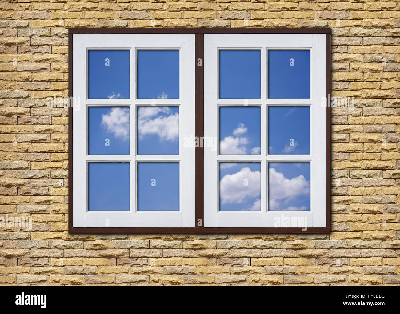 white wood window on stone walls and blue sky reflection window glass ...