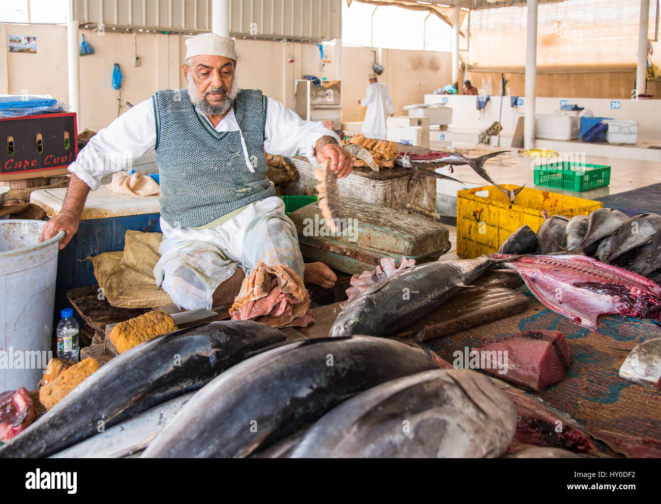 Vendor at the fish market in Muscat, Oman, with yellowfin tuna on the ...