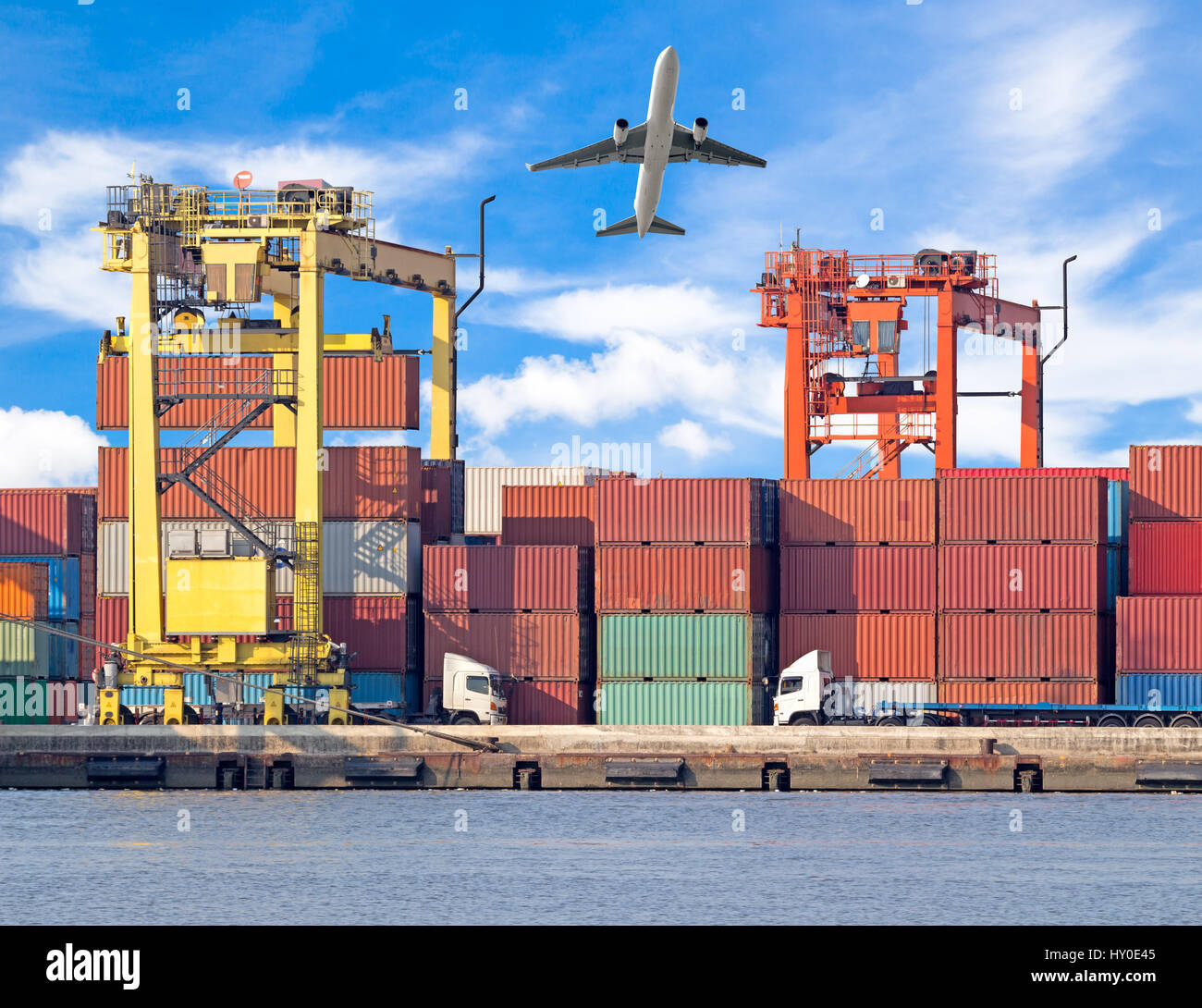 Container cargo freight ship with working crane loading bridge in ...