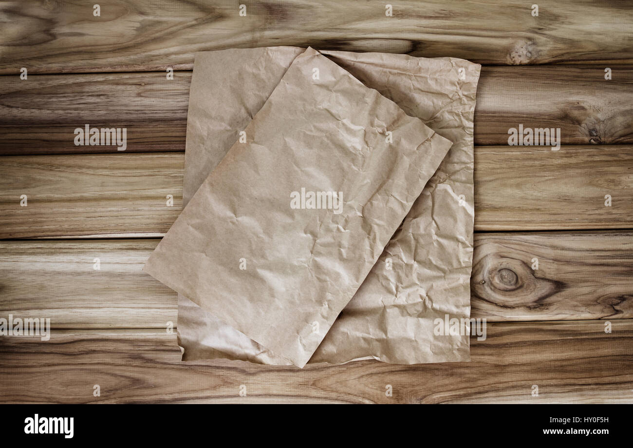 Crumbled cooking or baking paper sheet place on wooden table Stock ...