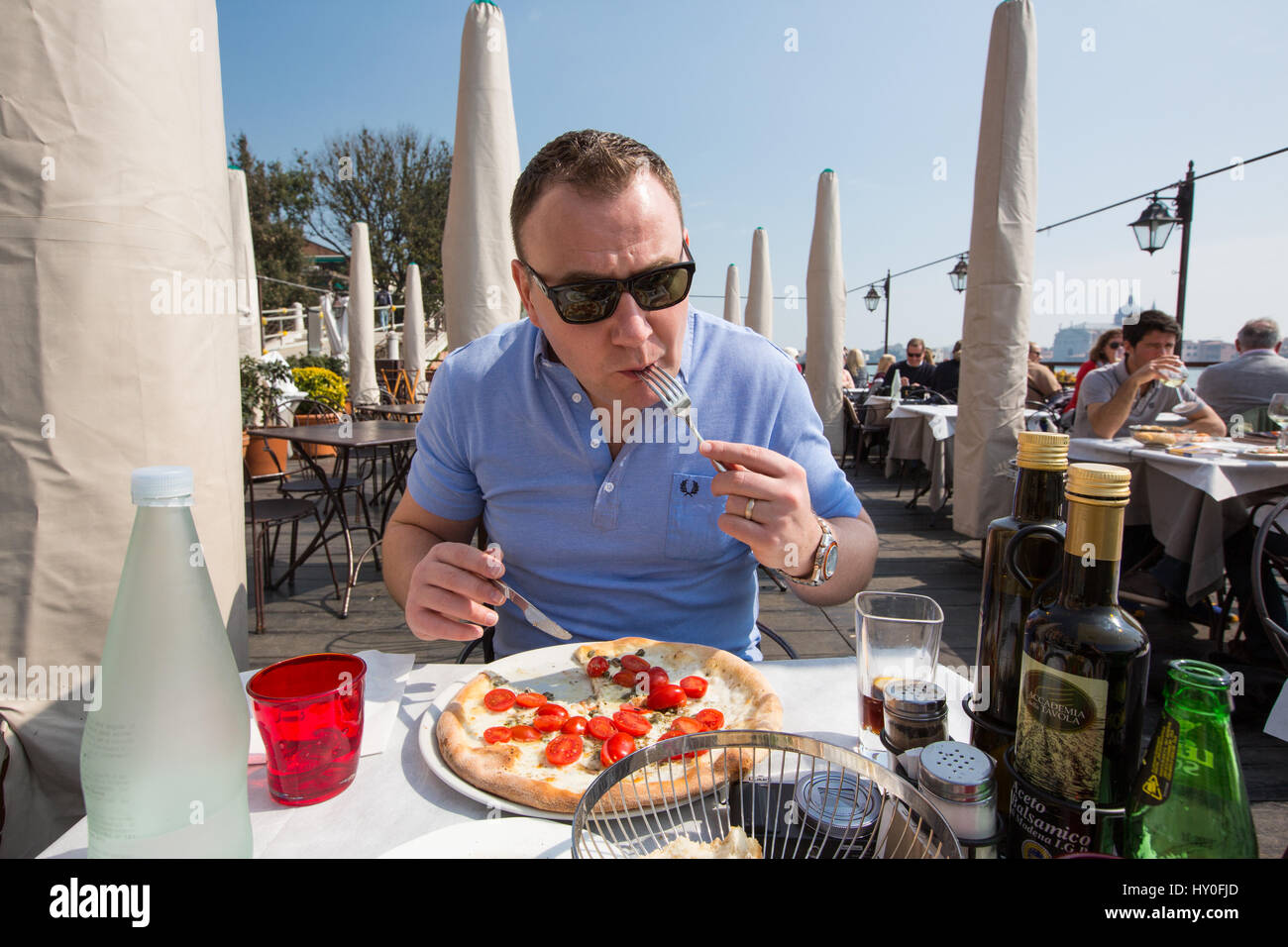 Man eating a pizza Stock Photo - Alamy