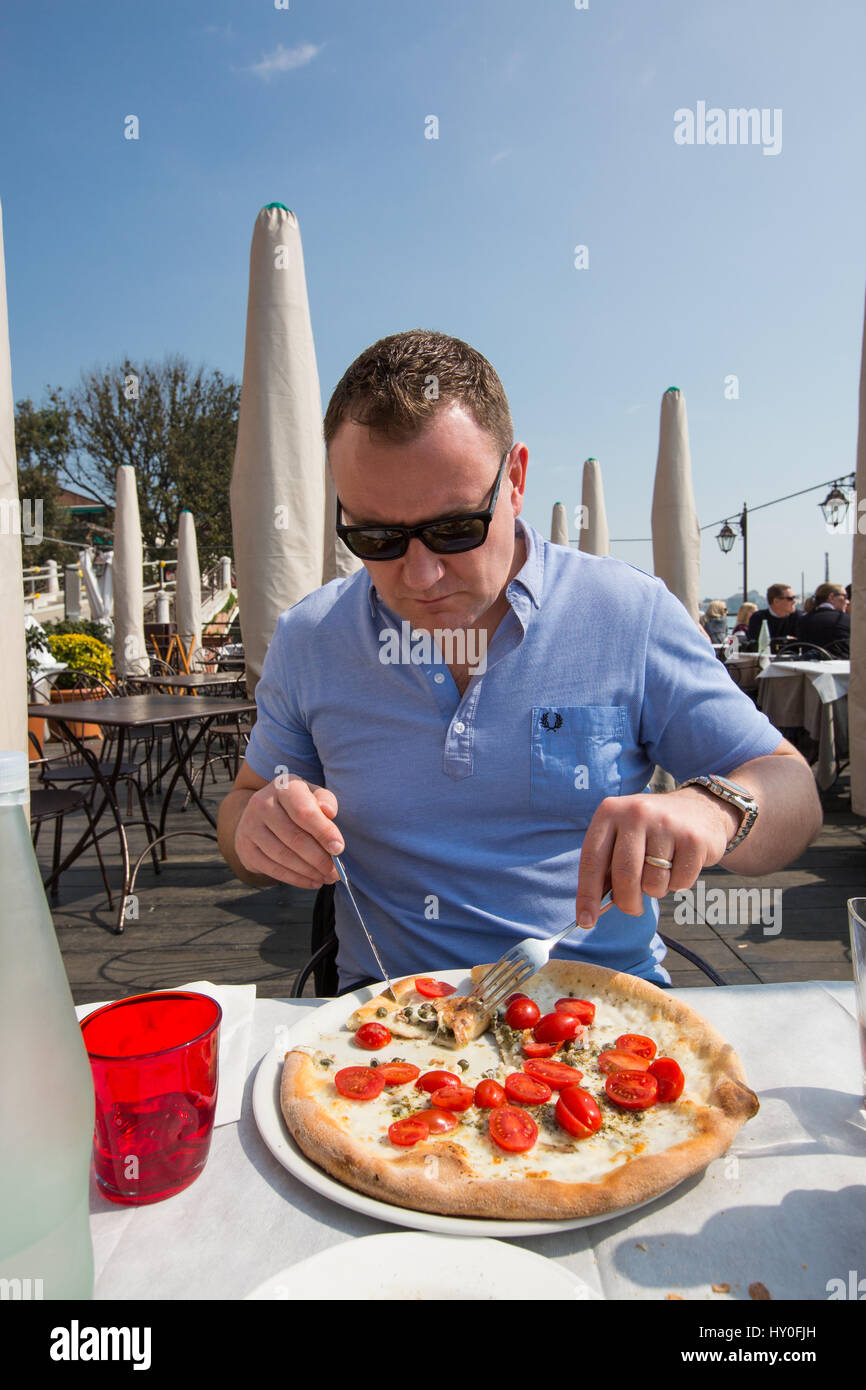 Man eating a pizza Stock Photo - Alamy