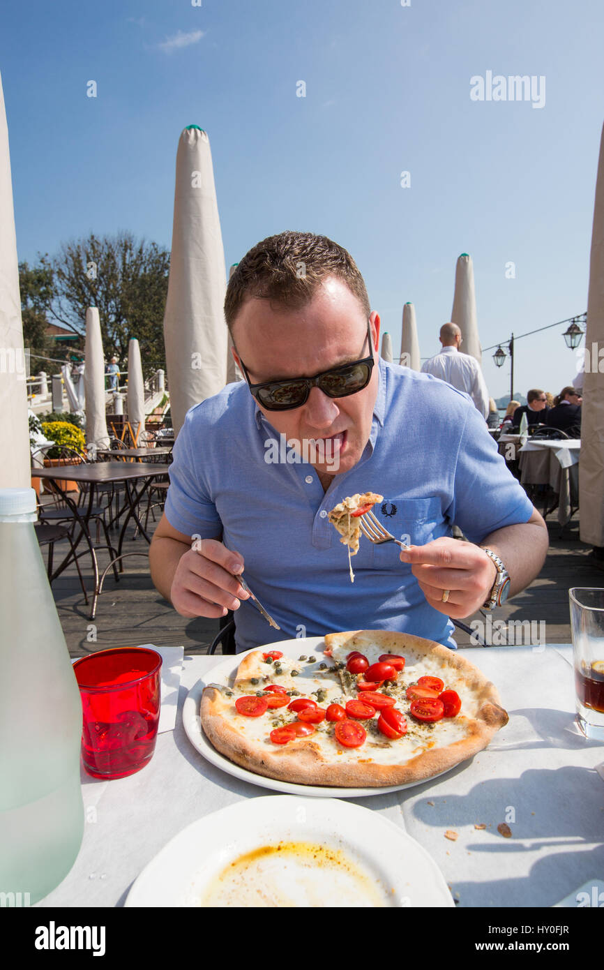 Man eating a pizza Stock Photo - Alamy