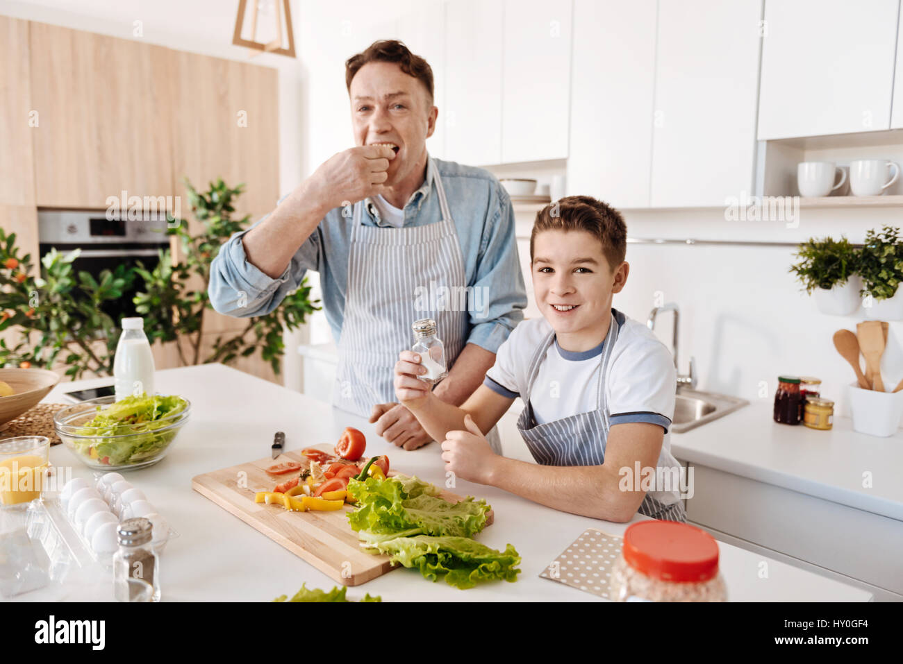 Great taste. Positive delighted son and his father cooking together and ...