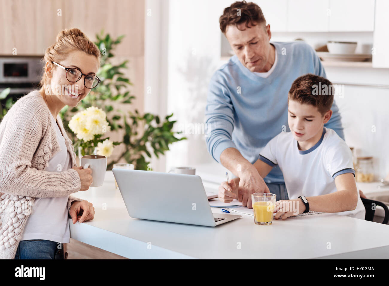 Caring father helping his son with home work Stock Photo - Alamy