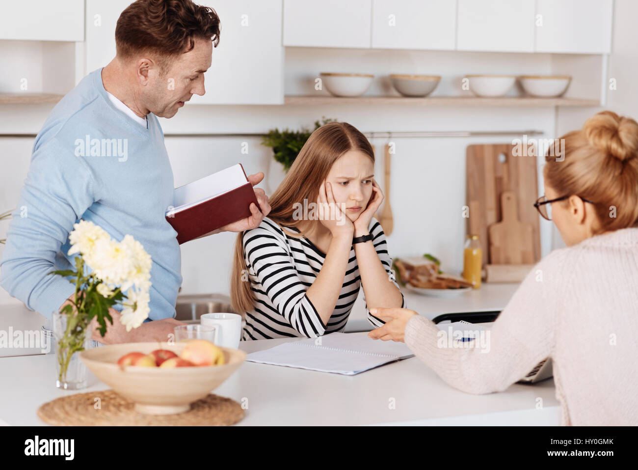Caring parents helping their daughter Stock Photo - Alamy