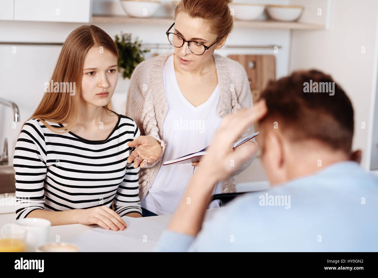 Strict parents scolding their daughter for bad results at school Stock ...